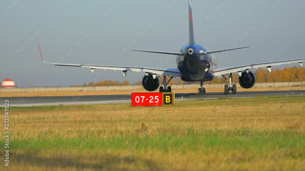 Commercial airplane aircraft moving and driving along runway at ...
