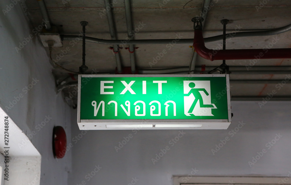 green emergency exit sign in public building Stock Photo | Adobe Stock