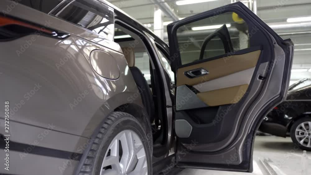 Open doors of new car in car salon. Action. View of interior of ...