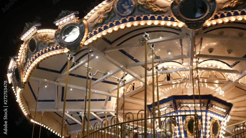 Illuminated merry go round in park. Brightly illuminated roundabout ...