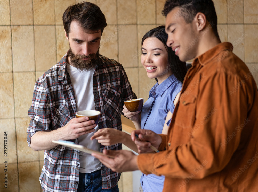 Group of happy multiracial friends drinking coffee together in cafe ...