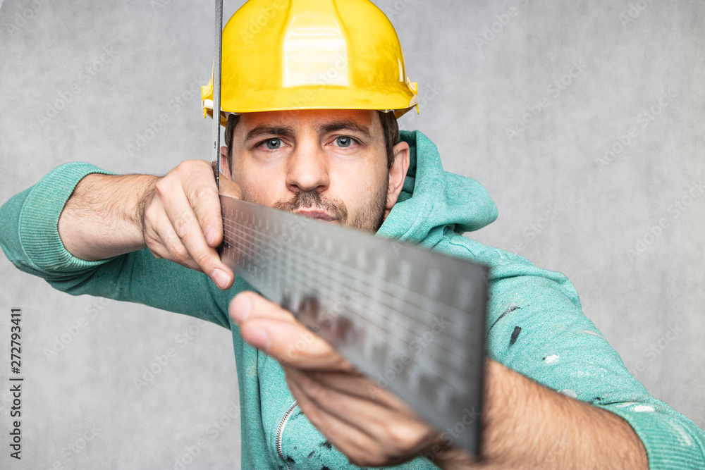 the construction worker is holding a angle in the hand, a guide to ...