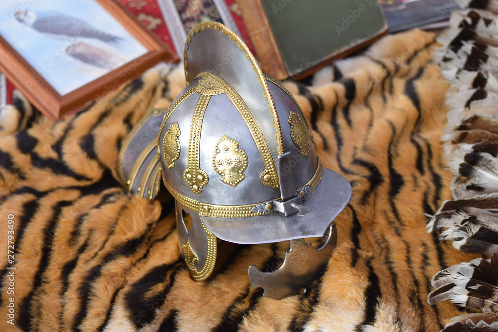 Shishak helmet of a medieval Polish hussar (cavalryman) on a tiger skin ...