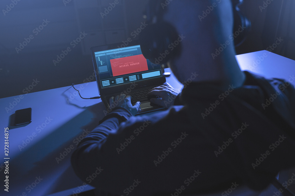 cybercrime, hacking and technology concept - male hacker in headphones ...