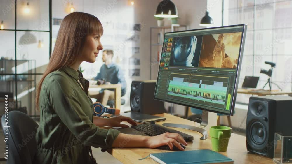 Beautiful Brunette Female Video Editor Works with Footage on Her ...