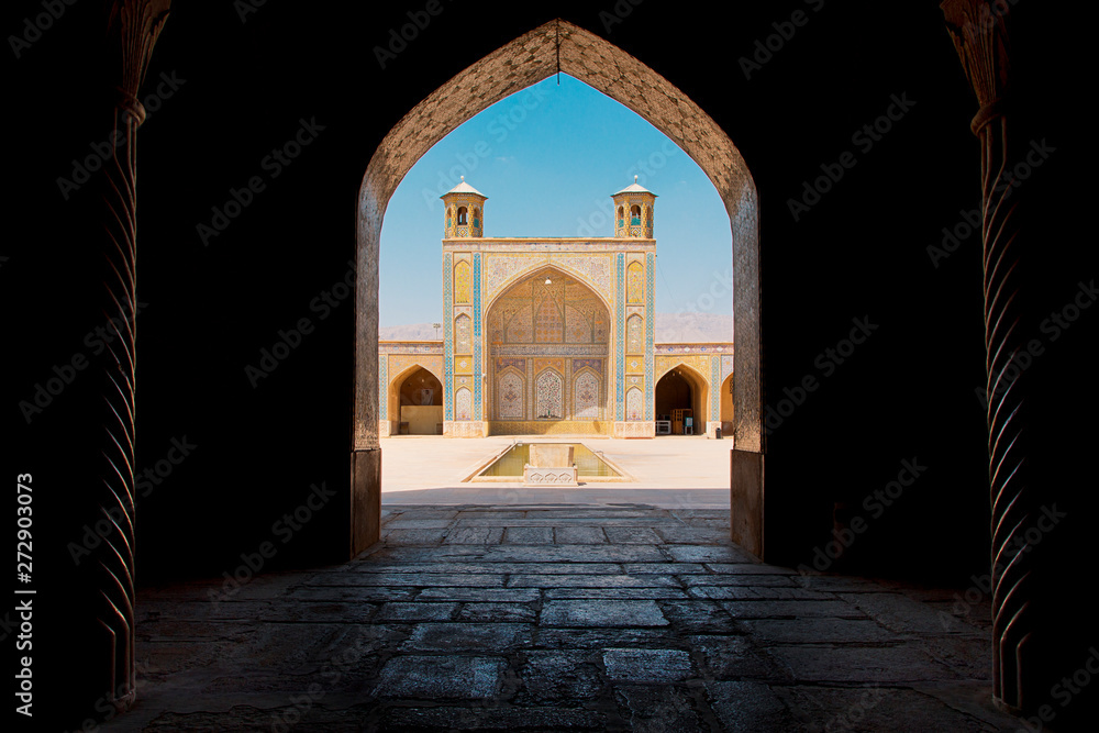Iran mosque viewed through dark gate Stock Photo | Adobe Stock