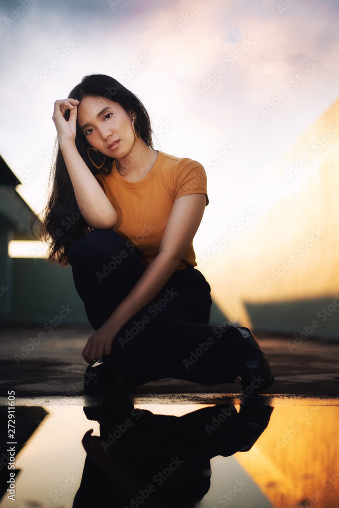 The girl has a skin color of honey or tan. Wearing orange shirt Street ...