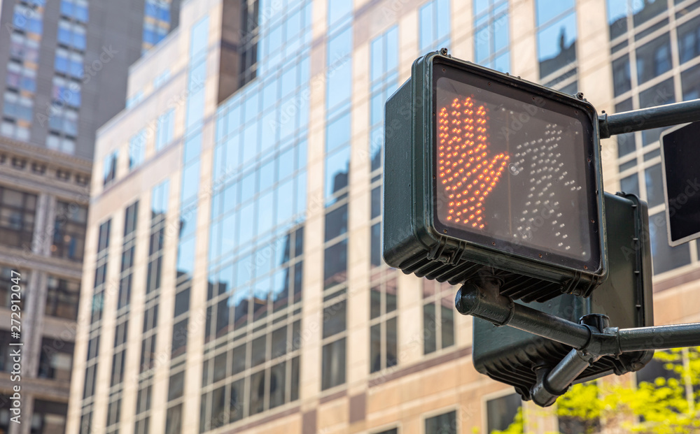 Stop, dont walk traffic sign for pedestrians, blur office buildings ...