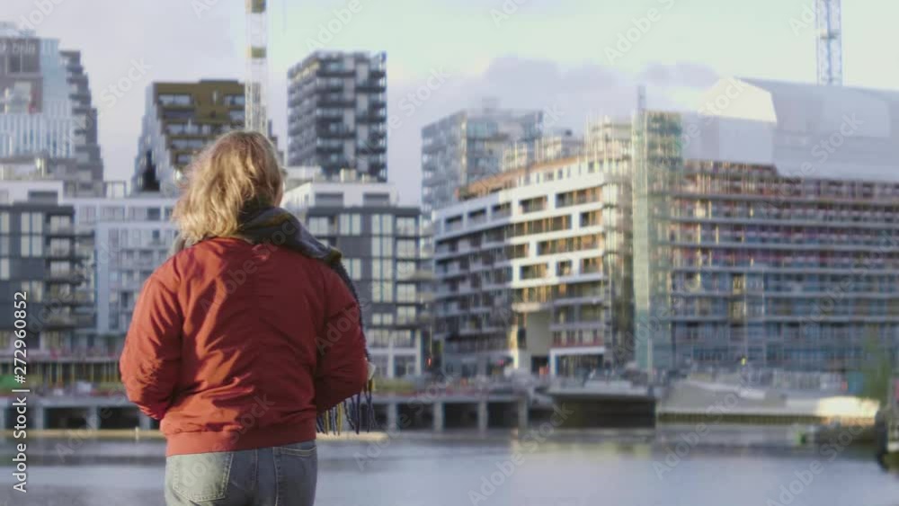 4K anamorphic video with gimbal pan motion of woman with jeans and a ...