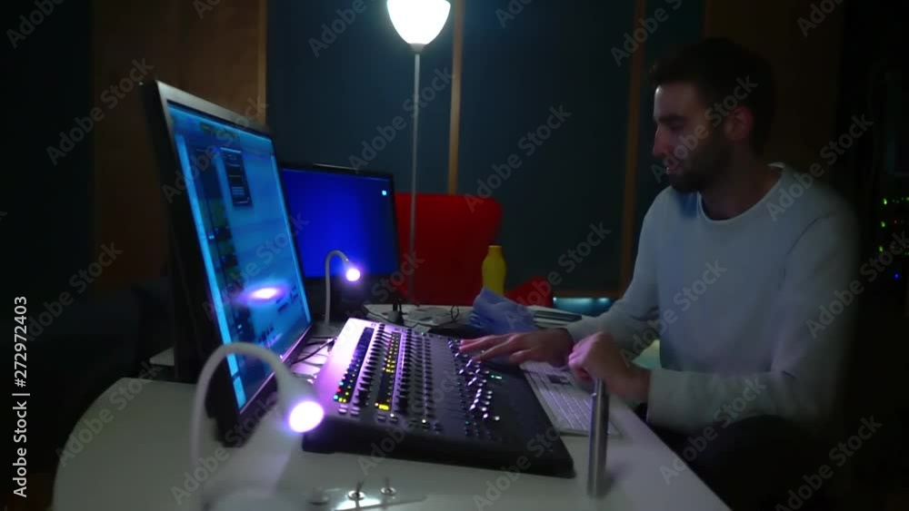 Shot of a sound engineered working on a studio using a mixer console ...