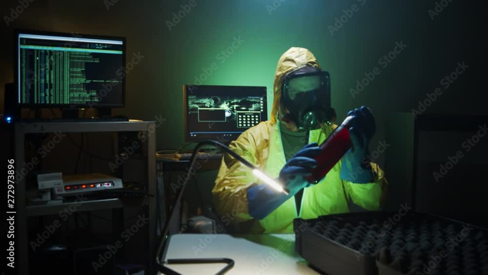 Bioterrorist examines a bottle of dangerous liquid Stock Video | Adobe ...