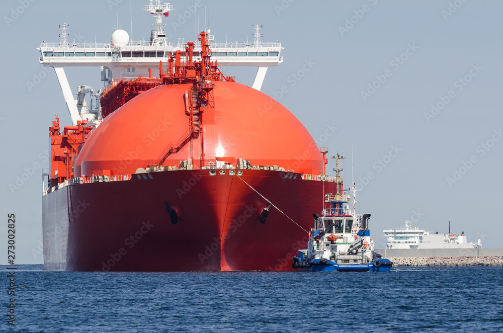 RED LNG TANKER - The big ship maneuvers in the mooring port at the ...