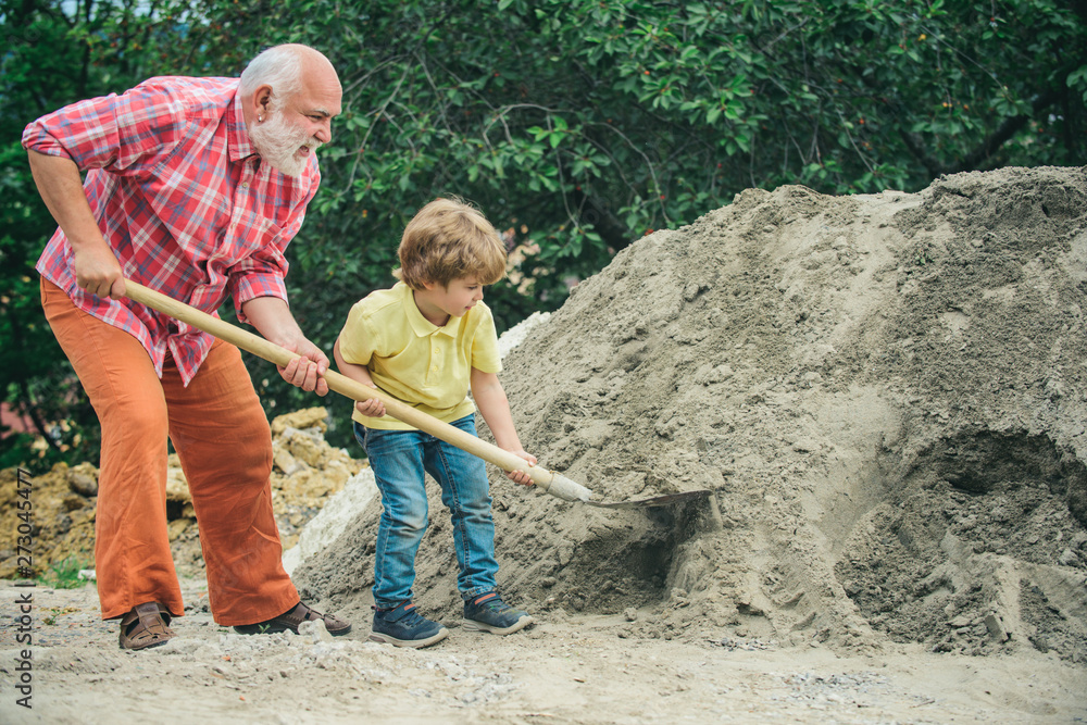 Grandfather with his grandson hard working. Little grandson helping his ...