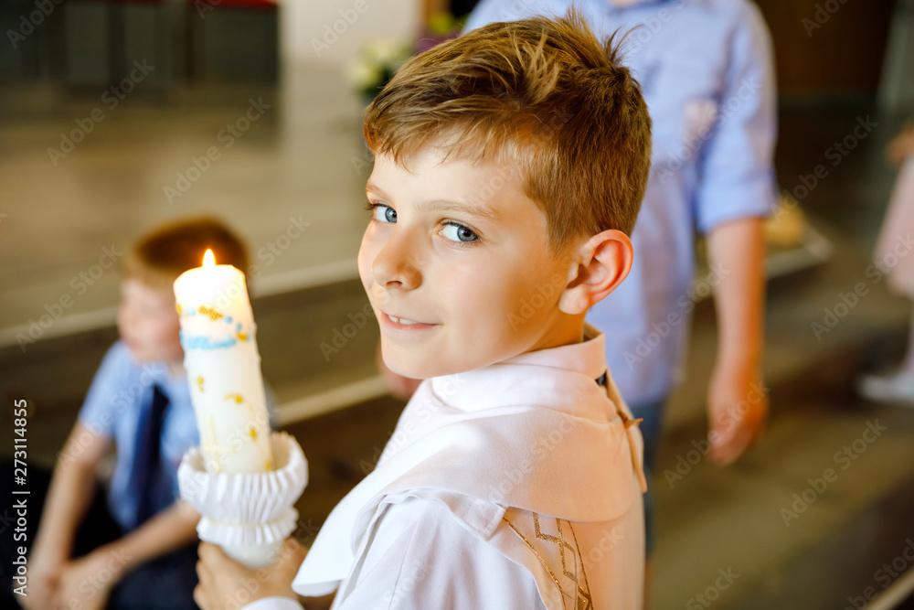 Little kid boy receiving his first holy communion. Happy child holding ...