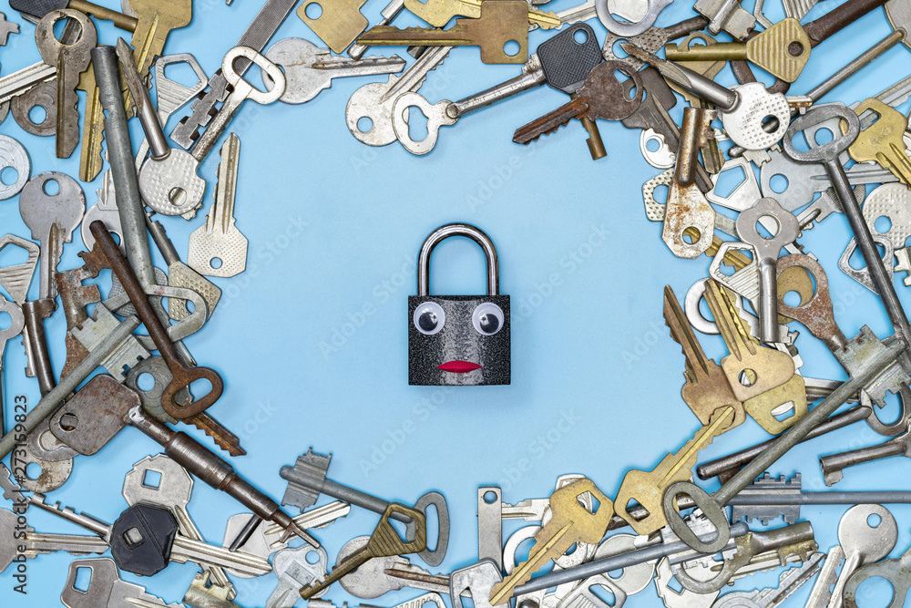 Keys set with funny lock in middle concept, blue background. Choosing ...