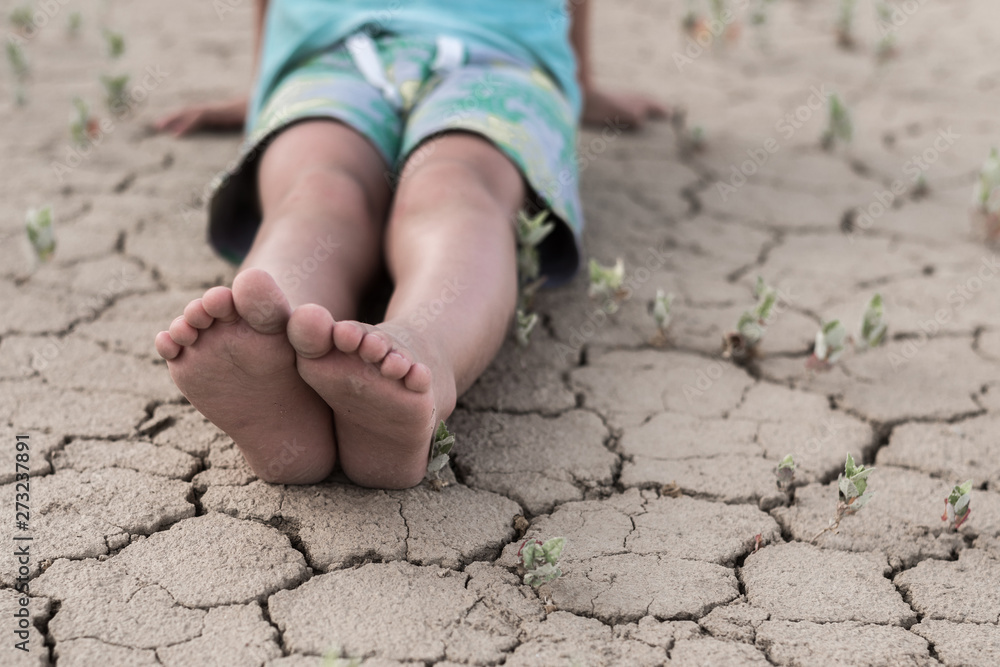 Fainting from heat, dehydration in a child. Children's feet lie on ...