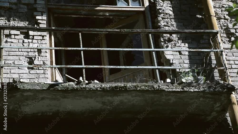 The facade of the old destroyed brick building with broken windows in ...