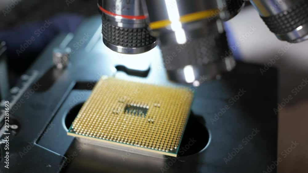 Processor is being examined for apparent defects under microscope. In ...