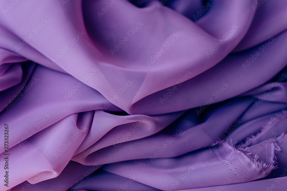 Purple fabric. The texture of the folds on the surface of the purple ...
