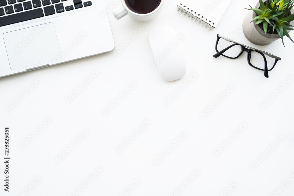 White office desk table with laptop computer and lop of supplies on it ...