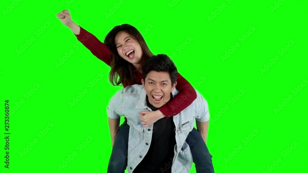 Cheerful young couple. Handsome man giving piggyback ride to his ...