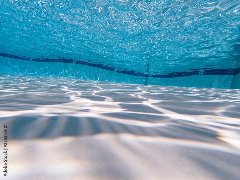 Abstract underwater light patterns on the bottom of empty suburban ...