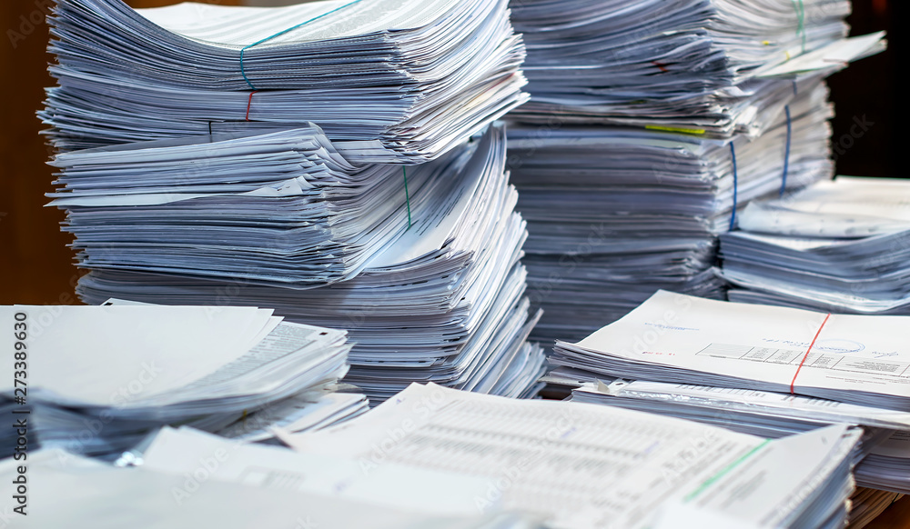bundles bales of paper documents. stacks packs pile on the desk in the ...