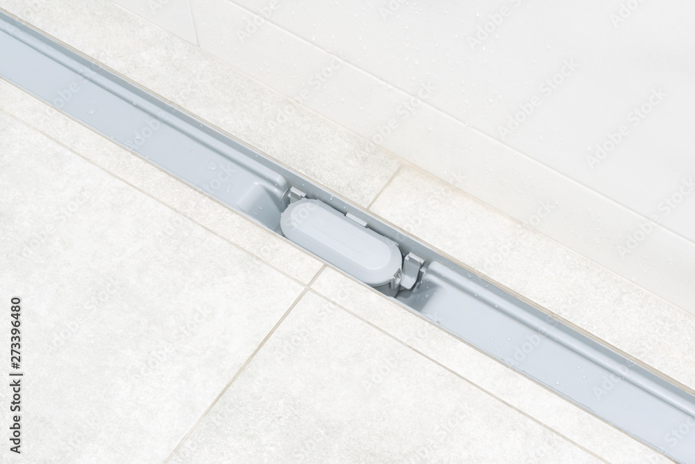 Clean linear shower drain system and siphon trap at bathroom. Under the ...