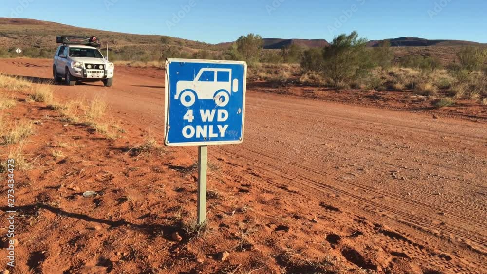 Woman driving a Four wheel drive vehicle driving on a 4 WD only road to ...
