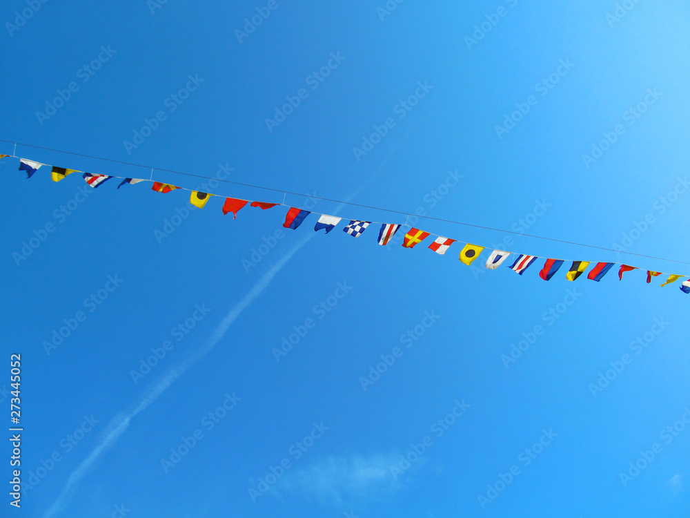 Nautical flags of sea cruise liner. Many colored marine flags hanging ...