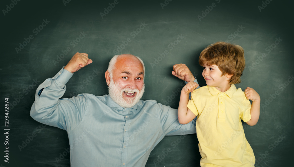 Elementary school kid and teacher with laptop in classroom at school ...
