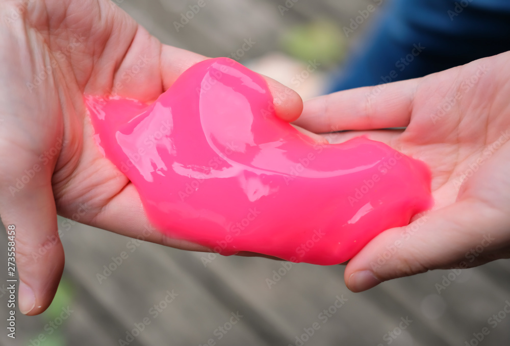 Pink anti stress toy slime in hands. Fighting anxiety and stress ...