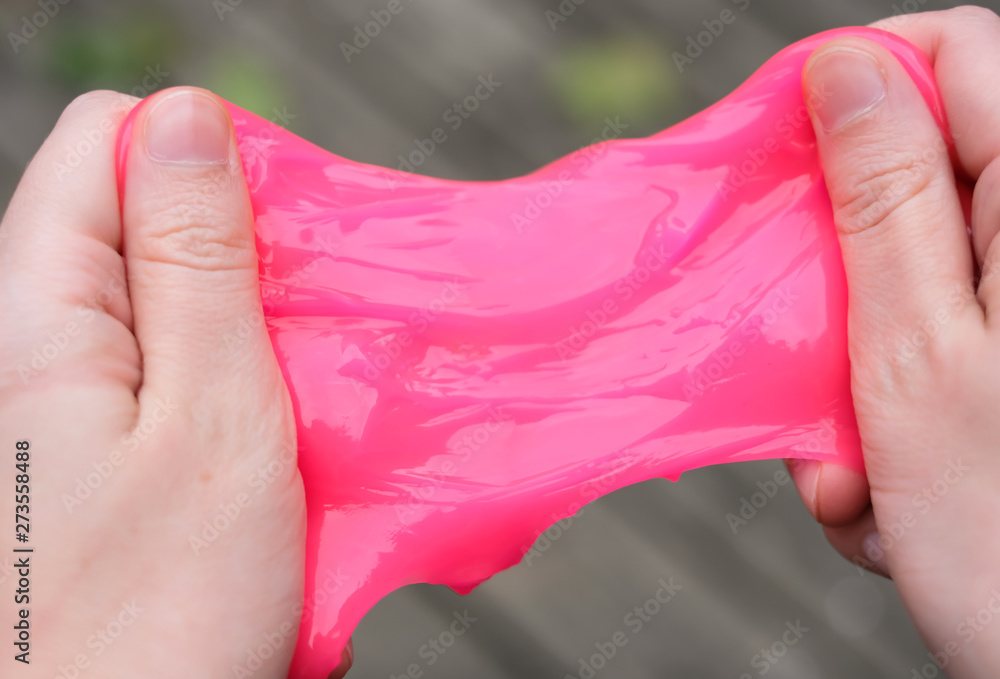 Pink anti stress toy slime in hands. Fighting anxiety and stress ...