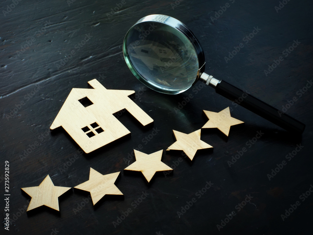 Property valuation and home appraisal. Model of house and five stars ...