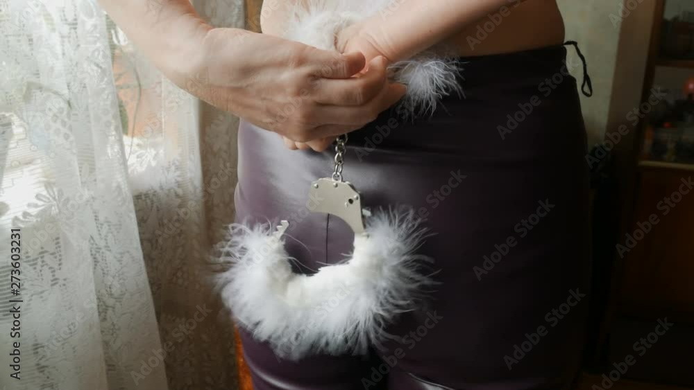 girl in leather pants trying to unfasten and remove the handcuffs Видео ...