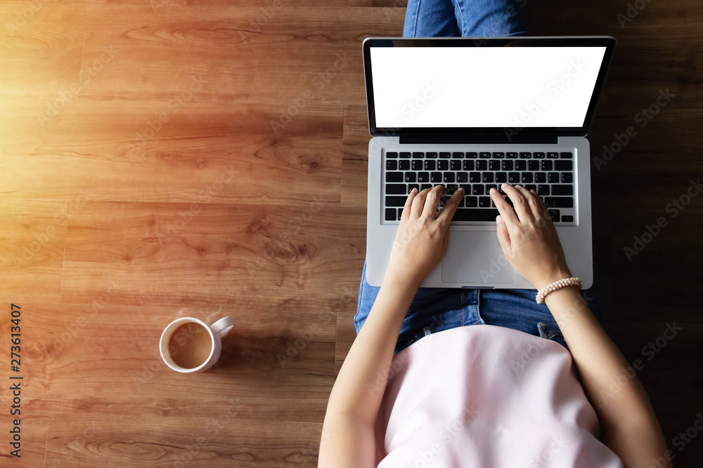 top view of woman typing on laptop computer with blank white screen ...