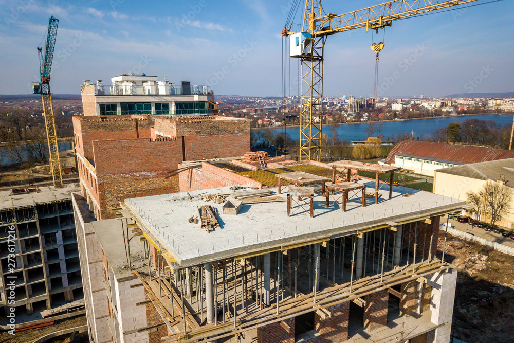 Apartment or office tall building under construction, top view. Brick ...