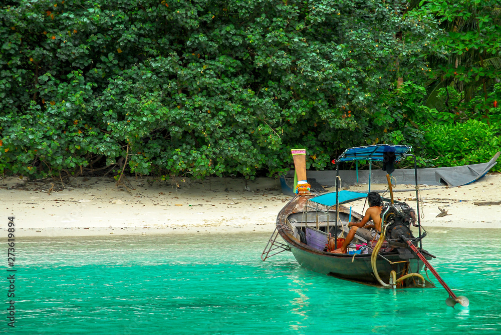Boat stopped at Loh Samah Bay beach with crystal clear water, island of ...