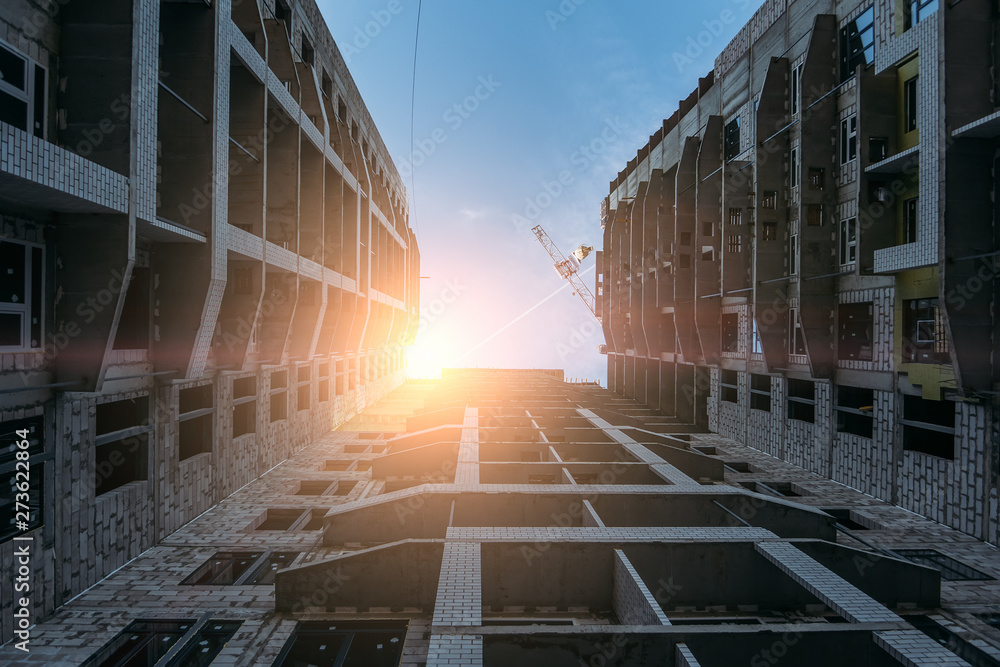 Construction site of new modern residential building at sunset sky ...