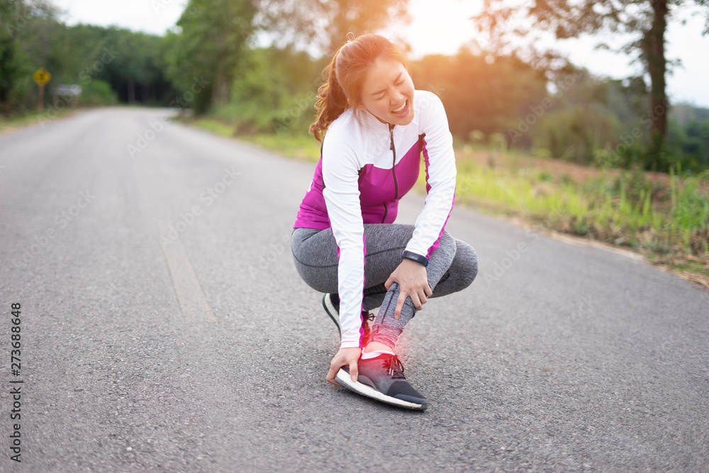 sport runner woman cramps in leg and feel pain, athletic young Asian ...
