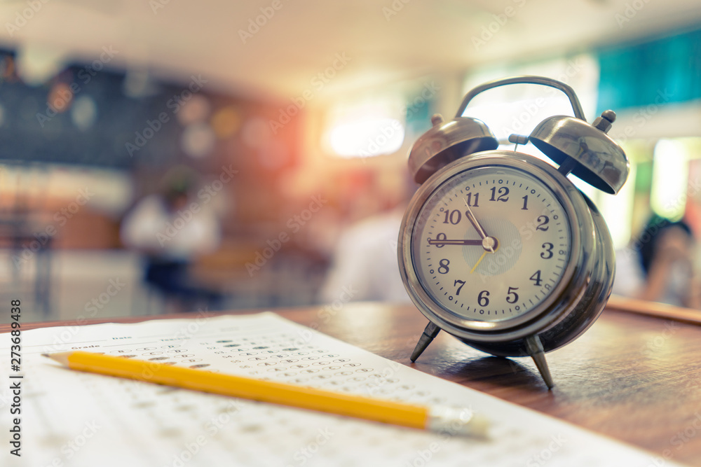 Test Examination in Education concept,pencil and Alarm clock on wooden ...
