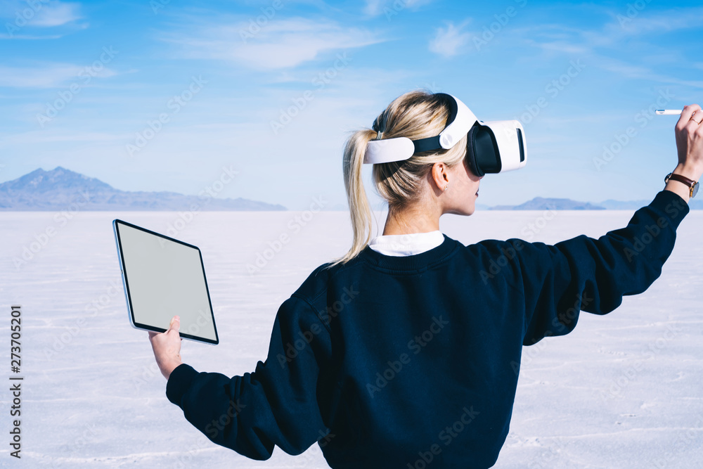 Back view of female gesturing with hand drawing digital sketches in ...