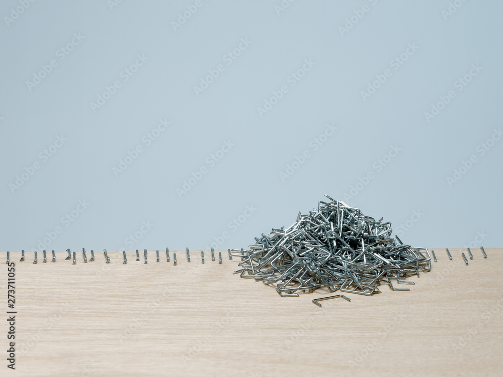 Silver metal stapler malfunctions creating precise row and random pile ...