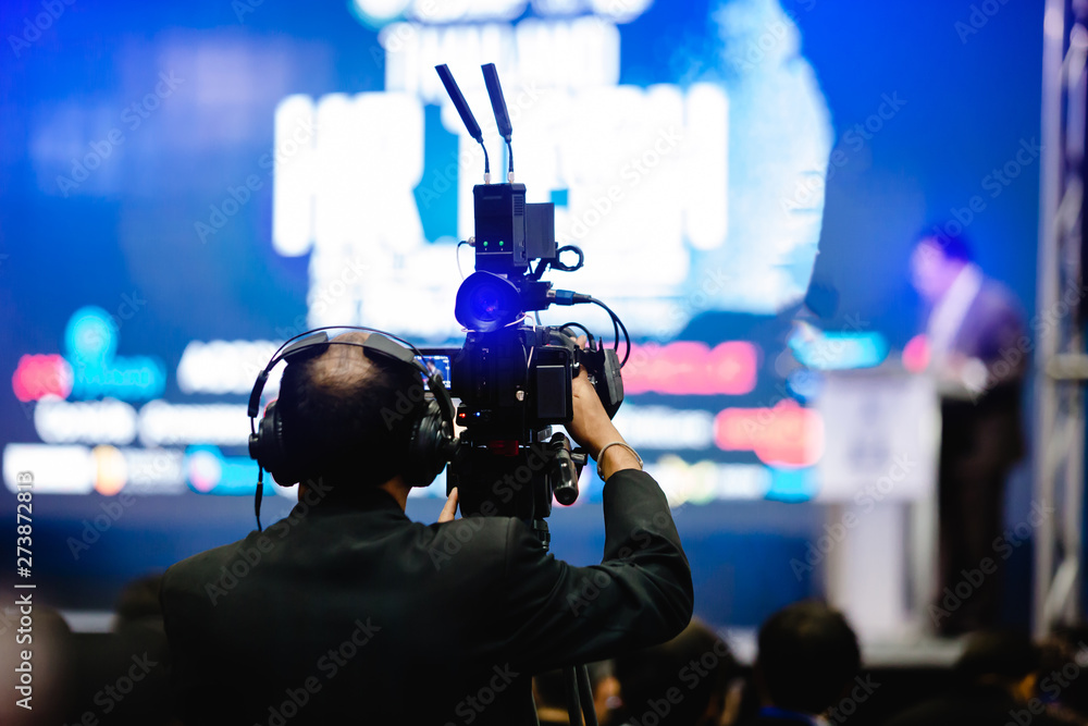 selective focus to cameraman and video camera set are recording to ...