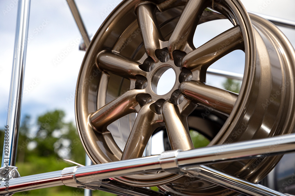 Modern metal alloy wheel for cars. Showcase with bronze colored rims ...
