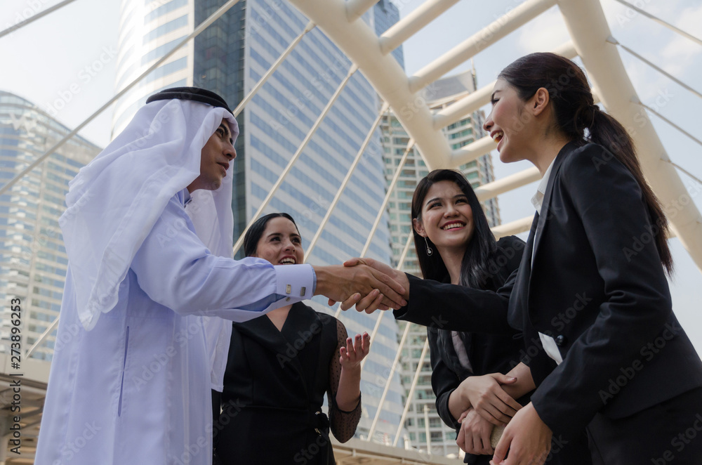 Deal. Welcome. group of Arabian business people handshake after ...