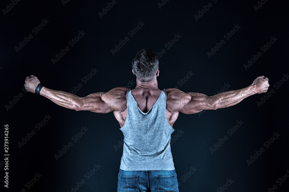 Dare to be great. Fit man back view. Fit athlete showing muscular power ...