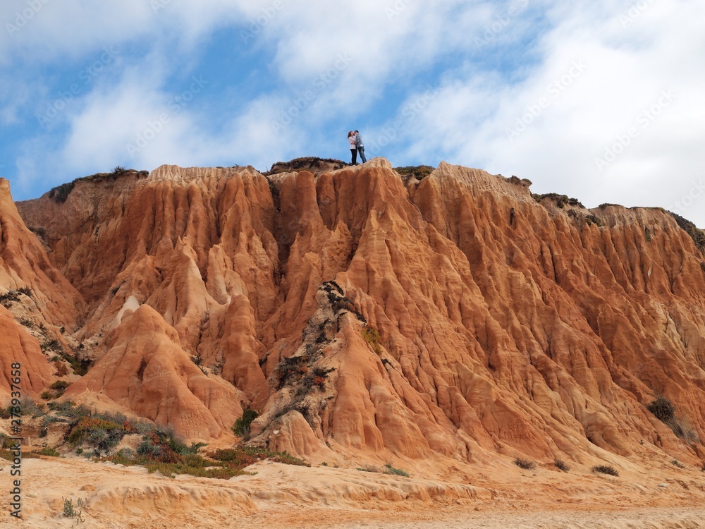 Red high cliffs at Praia da Falesia, a paradise beach in Albufeira in ...