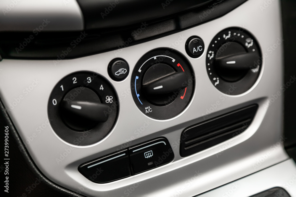 Black detail with the air conditioning button, inside a car. Close up ...