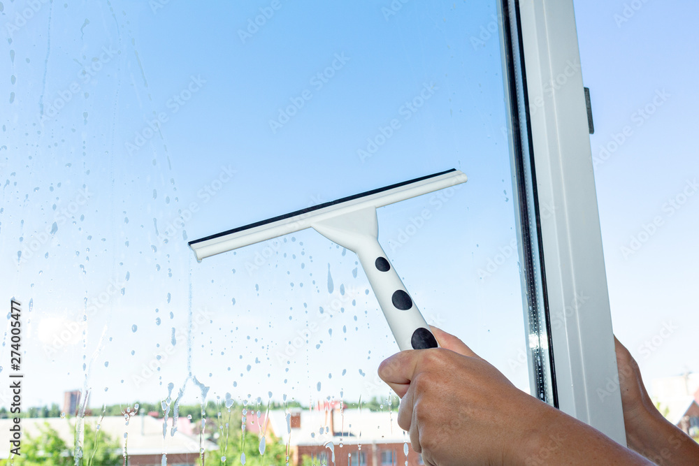 Washing cleaning windows by cleaning service hand with a special brush ...